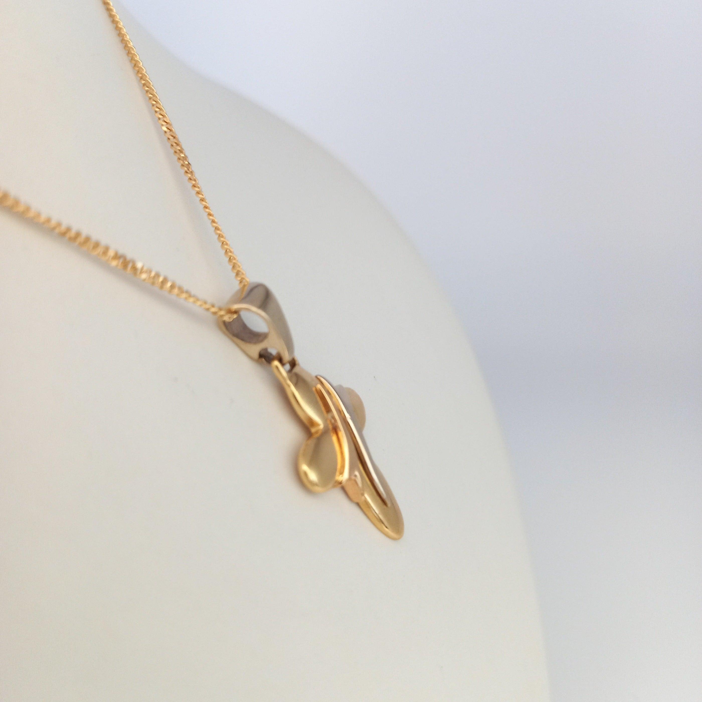 Gold cross pendant with elevated streaks